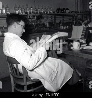 1950s, historical, male scientist in white coat at work in a chemical ...