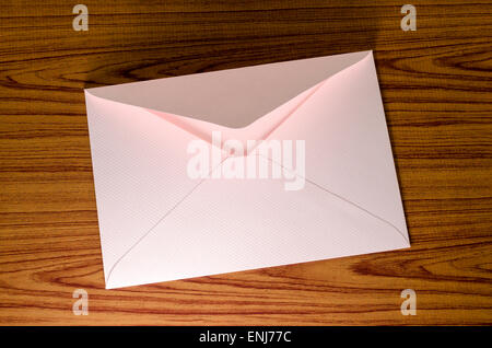 soft pink envelope on wooden background Stock Photo - Alamy