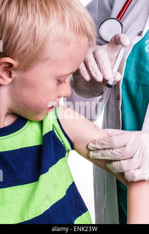 The doctor gives the child an injection in the buttock. Selective focus ...