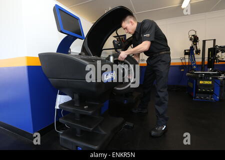 A Kwik Fit mechanic at work. Picture by James Boardman Stock Photo - Alamy