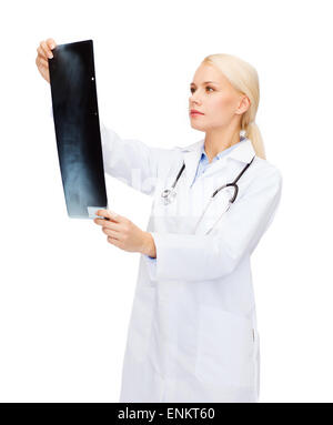 Serious doctor looking a radiography isolated on white background Stock ...