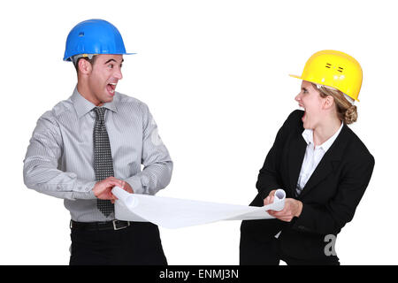 Two male construction workers fighting with tools and looking at each ...