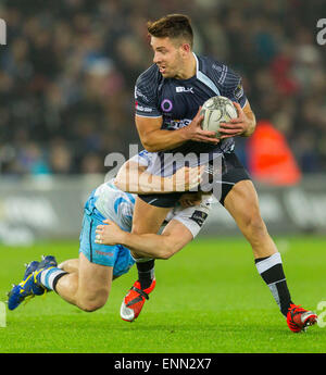 Rhys Webb of Ospreys Rugby, gets the ball away under pressure from Walt ...