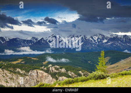 View on snowy mountains and cloudy sky in sun evening. Caucasus ...