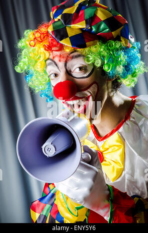 Clown in studio with loudspeaker Stock Photo - Alamy