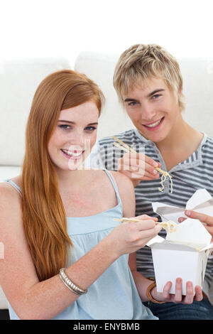 Boy and girl eating spaghetti together Stock Photo - Alamy