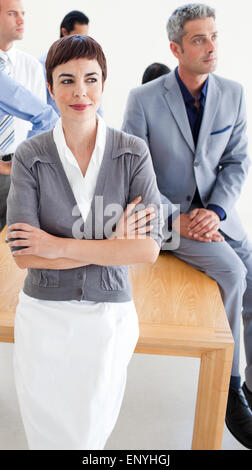 Assertive manager with folded arms in front of her team Stock Photo - Alamy