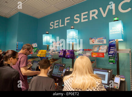people using Self Service checkouts, WH Smith, Gatwick airport, UK ...