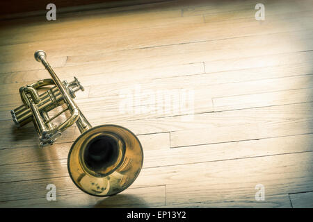 Old rusty trumpet lays on wooden floor in the morning light Stock Photo ...