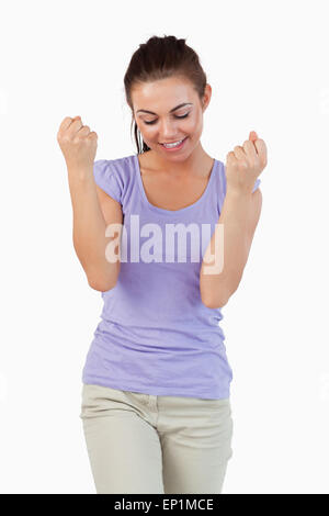 Victorious female person standing on mountain top with arms raised in V ...