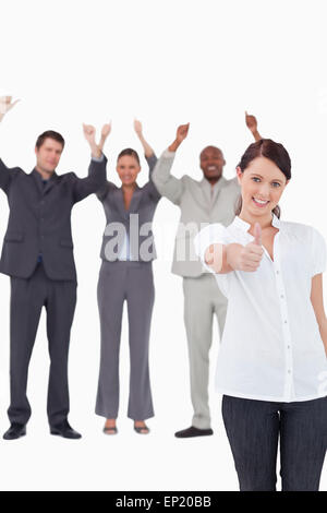 Smiling businessman with cheering team behind him Stock Photo - Alamy