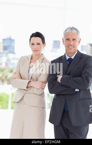 Businessman and his young secretary standing upright side by side Stock ...