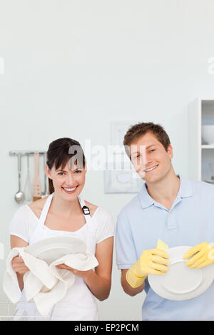 Lovers washing dishes together Stock Photo - Alamy