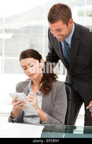 Smiling female manager taking folder from her colleague in office Stock ...