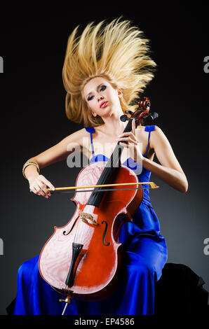 Attractive woman with cello in studio Stock Photo - Alamy