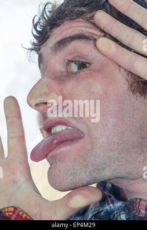Crazy lunatic man smooshes face against glass surfaces Stock Photo - Alamy