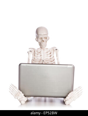 Skeleton working on laptop Stock Photo - Alamy