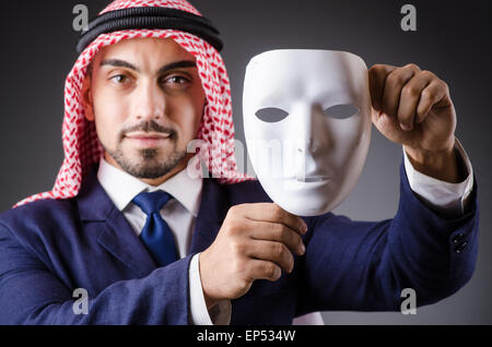 Arab with masks in dark studio Stock Photo - Alamy