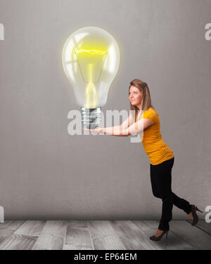 Beautiful lady holding realistic 3d light bulb Stock Photo - Alamy
