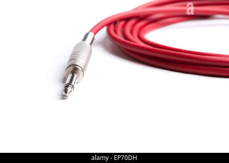 A red quarter inch cable for electric guitar isolated on a white ...