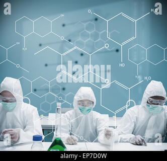 Chemists working in protective suit with futuristic interface showing ...