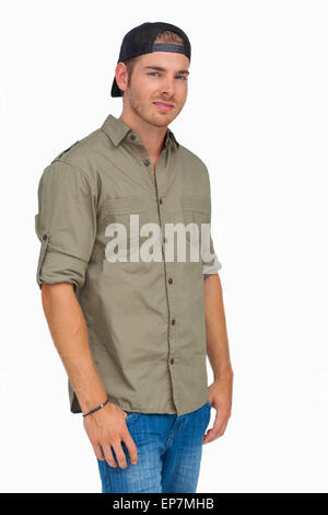 Man wearing baseball hat backwards and pointing Stock Photo - Alamy