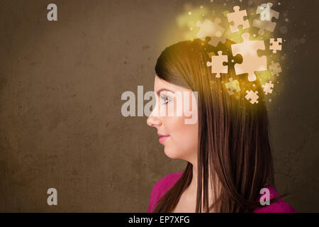 Young person thinking with glowing puzzle mind Stock Photo - Alamy