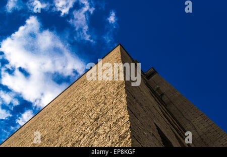 Modern skyscraper constructed with sharp edges against a cloudy sky in ...