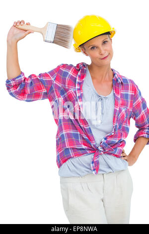 Attractive handy woman holding a brush and smiling at camera Stock ...