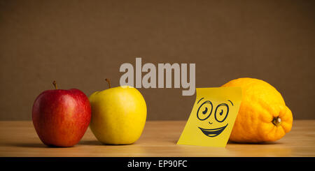 Apple with post-it note watching at lemon Stock Photo - Alamy