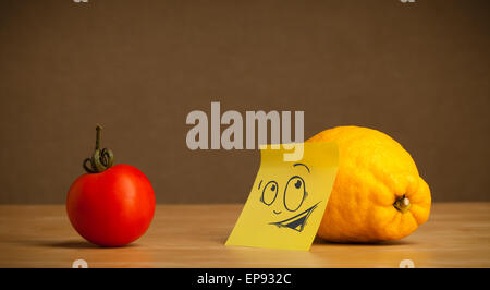 Lemon with post-it note looking curiously at kiwis Stock Photo - Alamy
