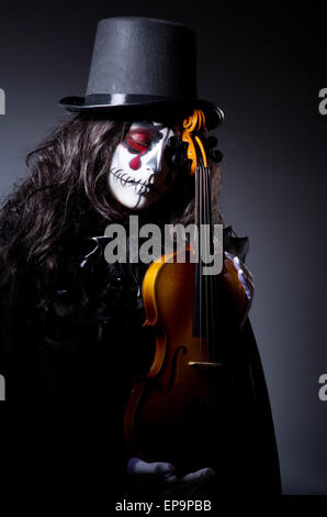 Monster playing violin in dark room Stock Photo - Alamy