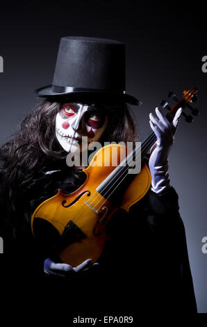 Monster playing violin in dark room Stock Photo - Alamy