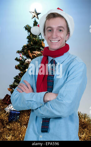 Cheerful man in a santa hat holding a banner holiday studio posing ...