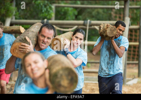 Man carrying log on shoulders outdoors Stock Photo - Alamy