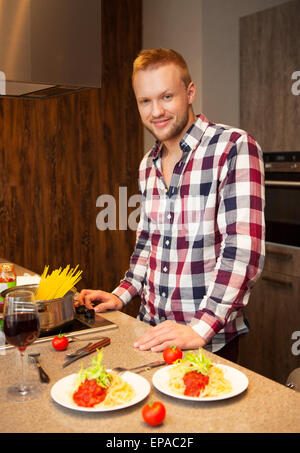Handsome man cooking pasta at home Stock Photo - Alamy