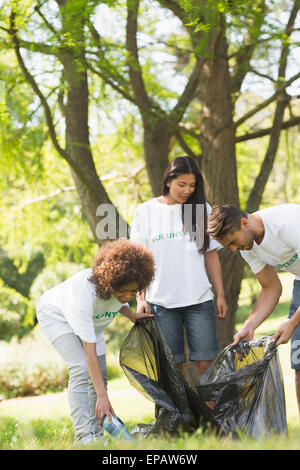 young volunteers cleaning lawn in park Stock Photo - Alamy