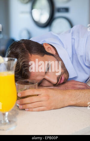 Drunk man slumped on bar asleep Stock Photo - Alamy