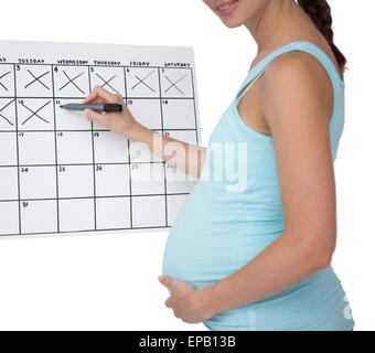 Pregnant woman marking off a calendar Stock Photo - Alamy