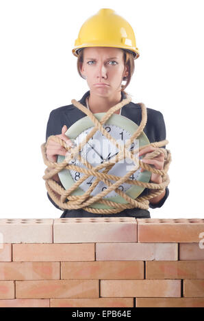 Female builder and clock on white Stock Photo - Alamy