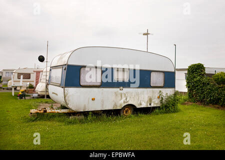 An old, run-down caravan has been parked on a lawn for the rest of ...