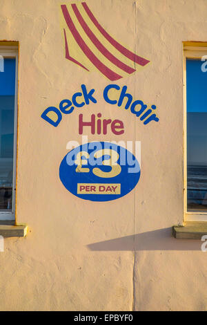 Bright and colourful striped deck chair on pier Stock Photo - Alamy