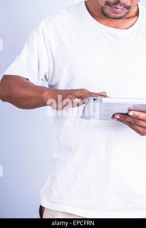 Closeup young man using tablet computer on exotic resort Stock Photo ...