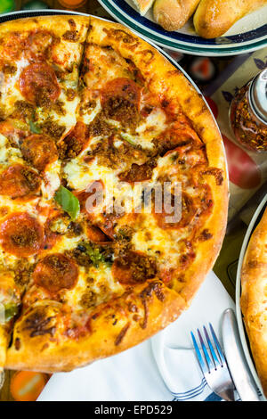 Fresh combo pizza in Italian restaurant Stock Photo - Alamy