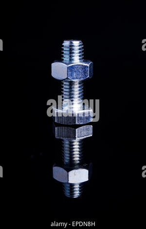 Silver nuts and bolts with black background Stock Photo - Alamy