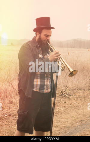 Stylish bearded gypsy plays trumpet on a wilderness path Stock Photo ...