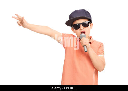 Adorable little boy singing on stage during a play standing with ...