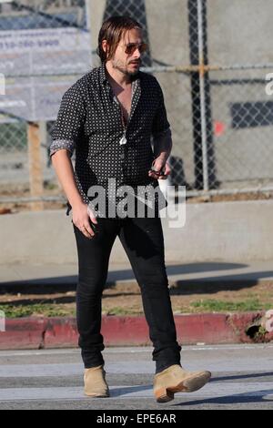 Marco Perego exits the Andy LeCompte hair salon with wet hair ...