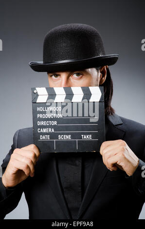 Man with movie clapperboard and hat Stock Photo - Alamy
