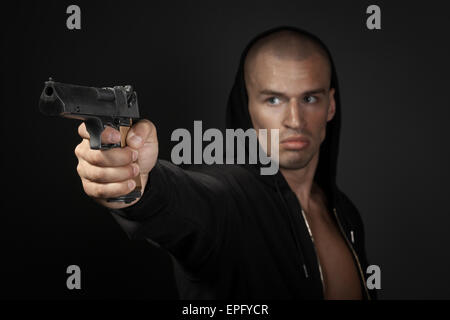 man shooting gun isolated on gray background Stock Photo - Alamy